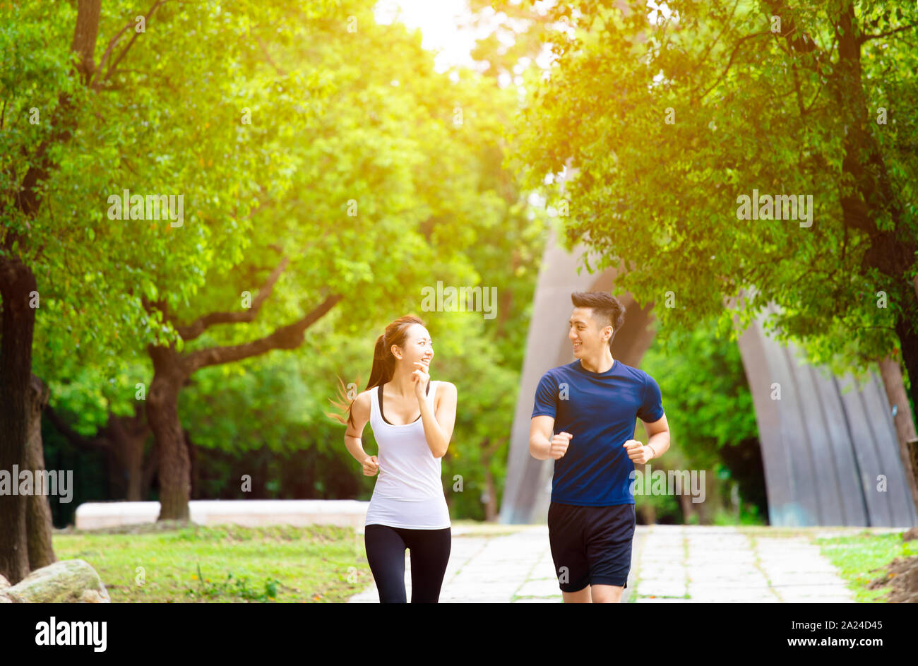 happy Couple jogging and running in nature Stock Photo - Alamy