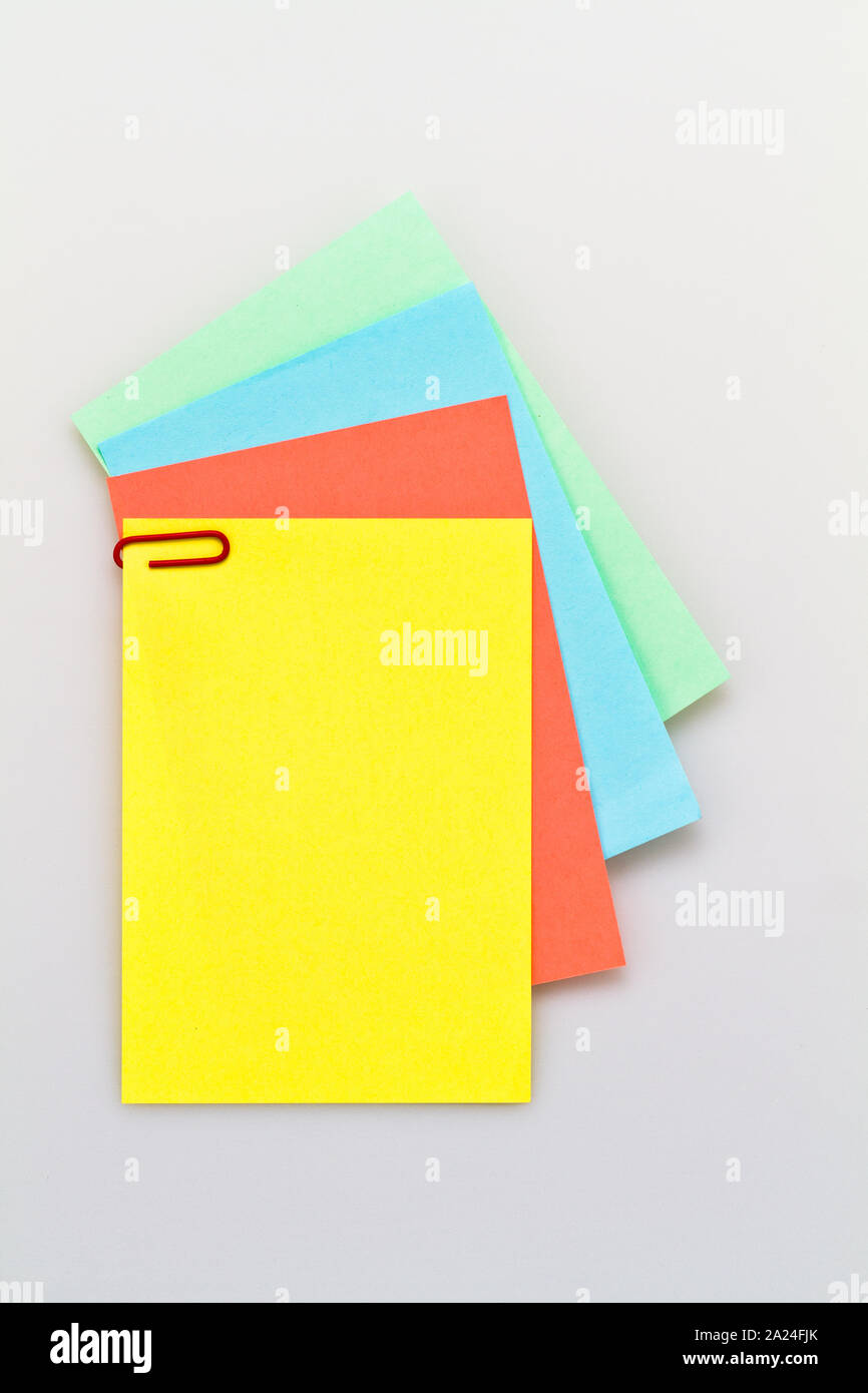 clipped colorful notepad on white background Stock Photo - Alamy
