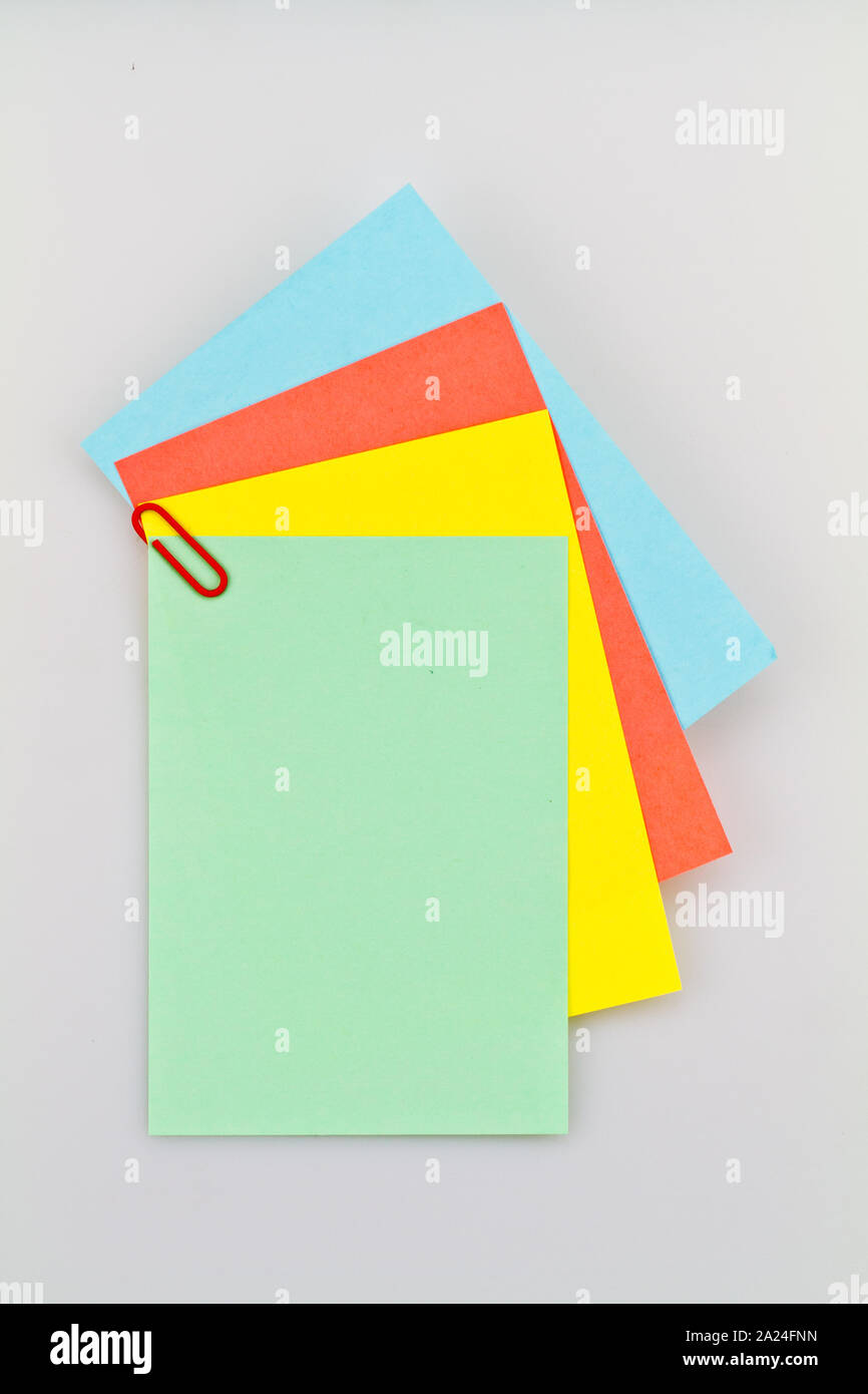 clipped colorful notepad on white background Stock Photo - Alamy