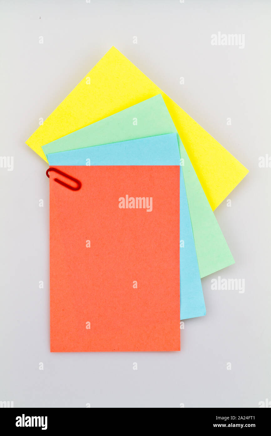 clipped colorful notepad on white background Stock Photo - Alamy