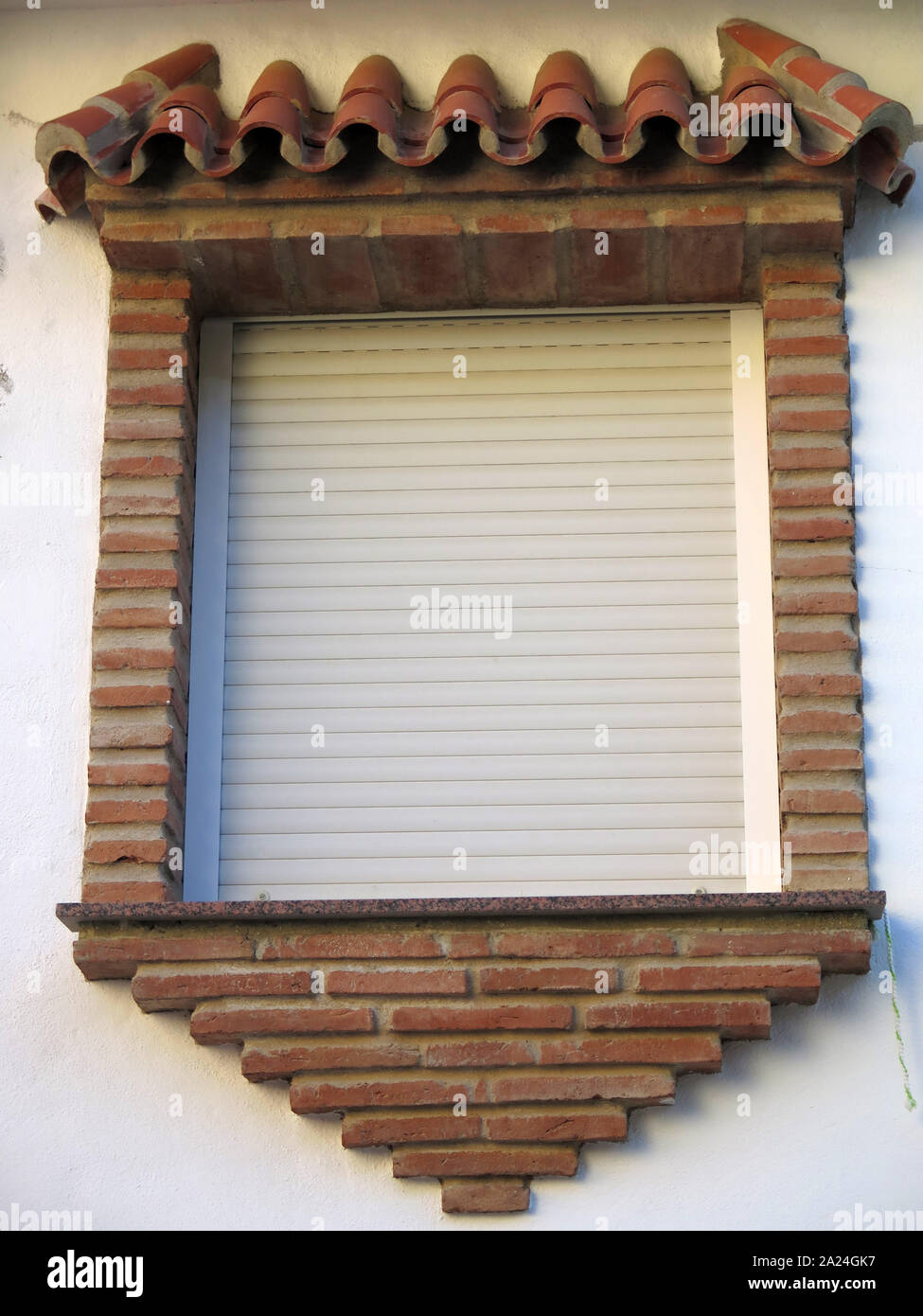 Brick suround arabic style window with closed white blinds Stock Photo ...