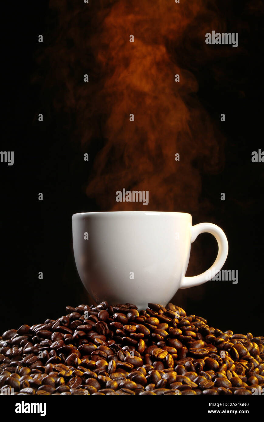 Coffee beans and smoke on a black studio background Stock Photo - Alamy