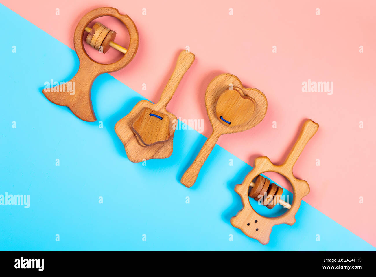 Minimalistic flat lay with a wooden rattle fish, bear,heart, star of ...