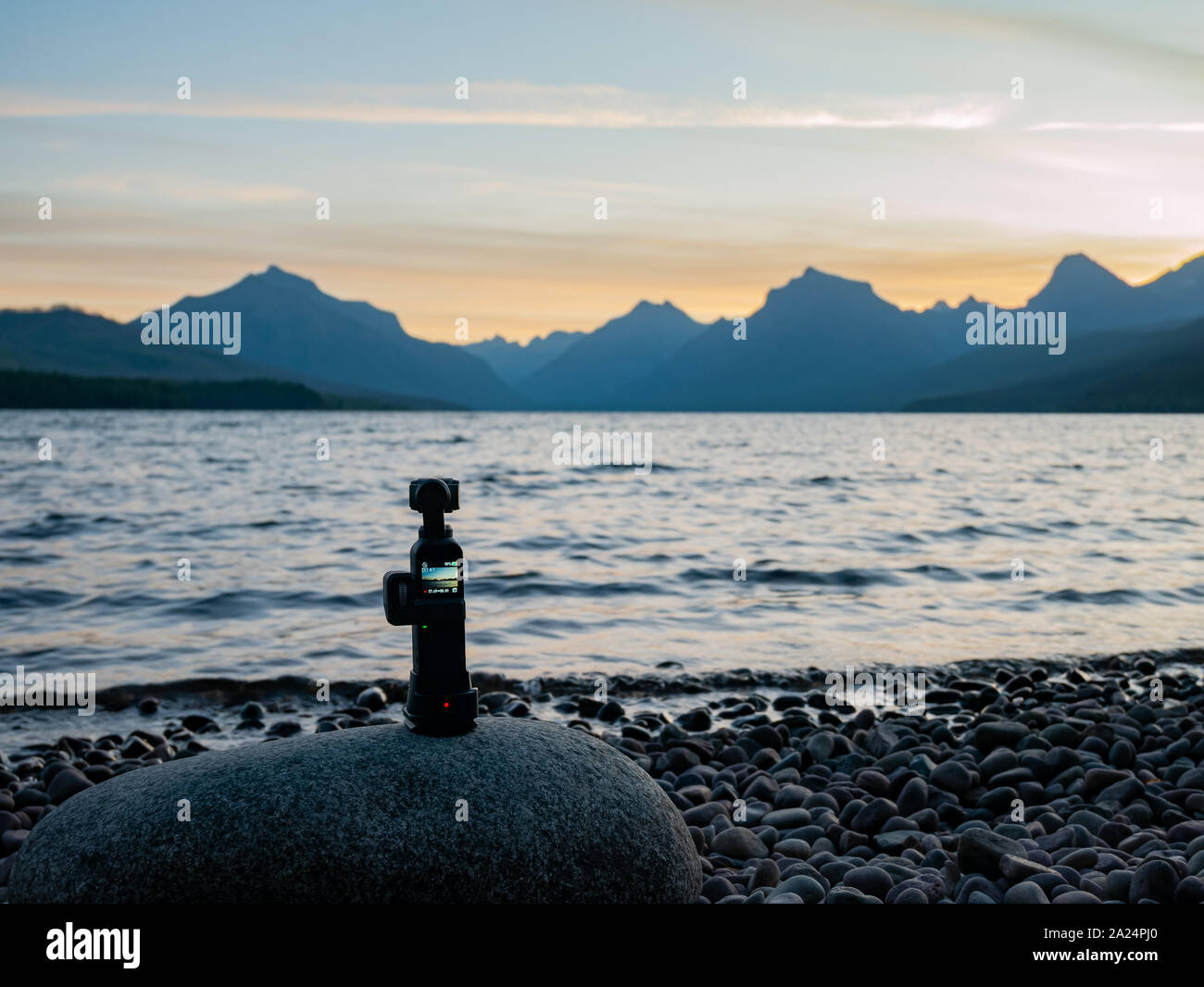 Camera taking picture of the beautiful sunrise of the Lake Mcdonald at ...
