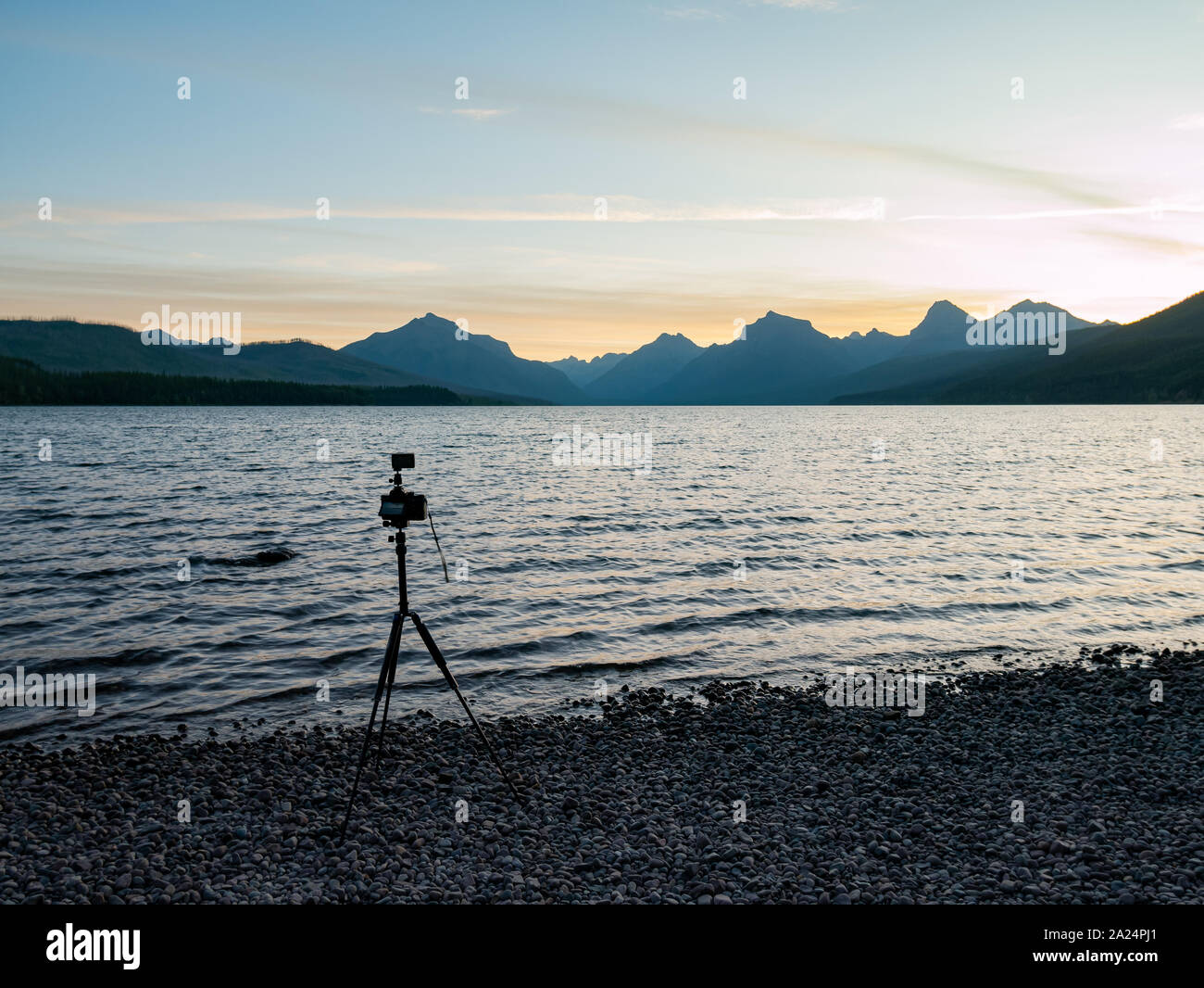 Camera taking picture of the beautiful sunrise of the Lake Mcdonald at ...