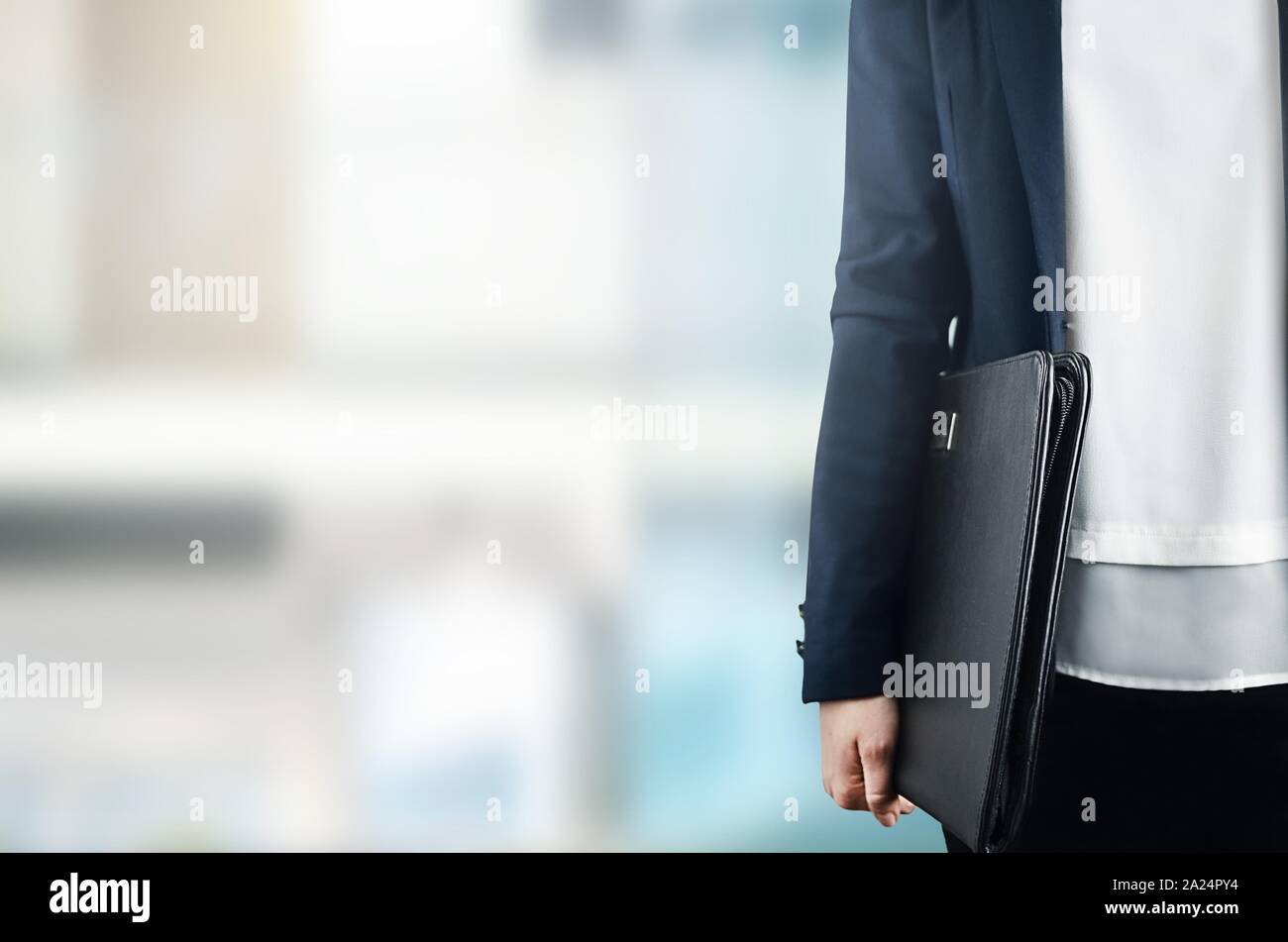 Businesswoman with documents in office background Stock Photo - Alamy