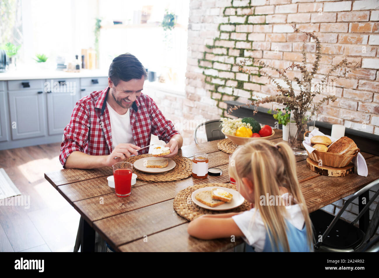 Daddy and daughter eating yummy toasts for breakfast Stock Photo - Alamy