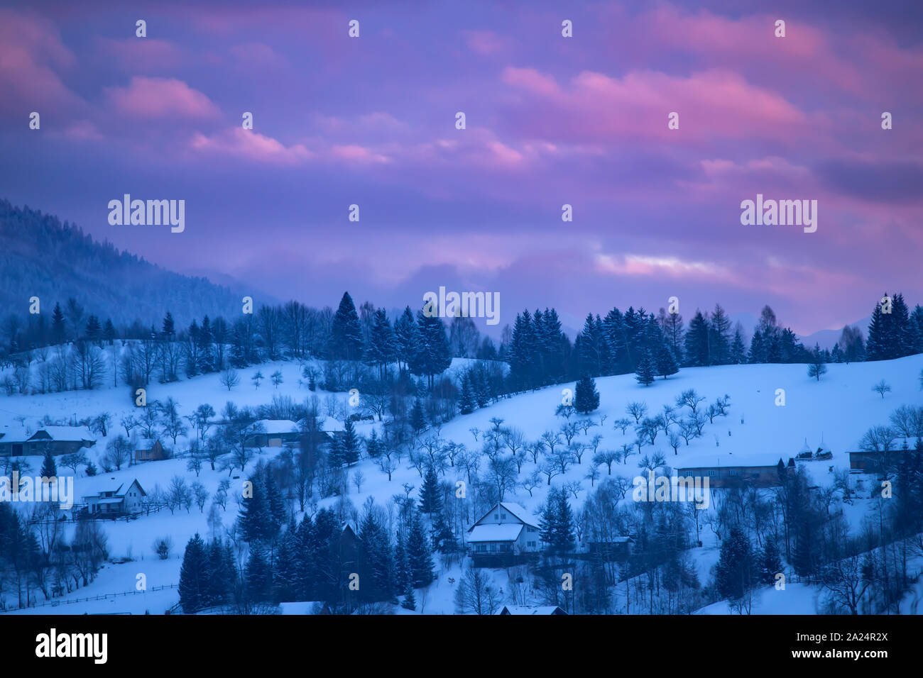 Pink sunset over snowy mountains Stock Photo - Alamy