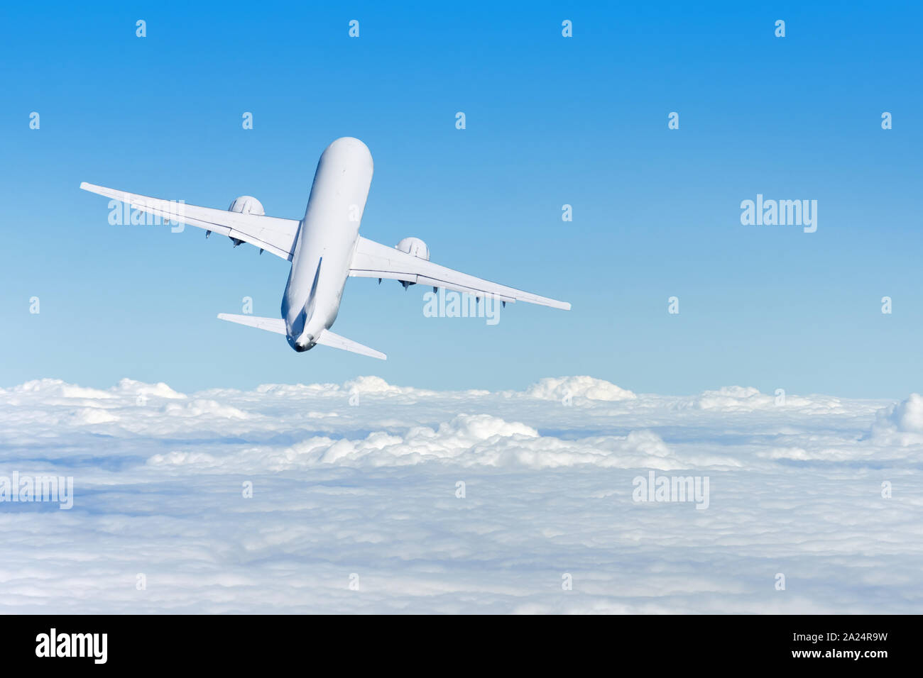 Airplane gains altitude flying into the distance above the clouds, rear ...