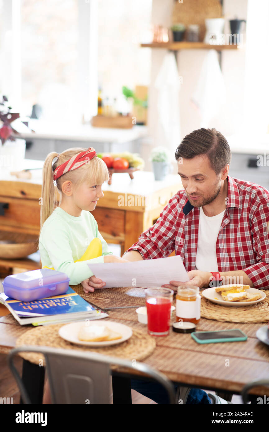 Daddy looking at schedule of his daughter before going to school Stock ...