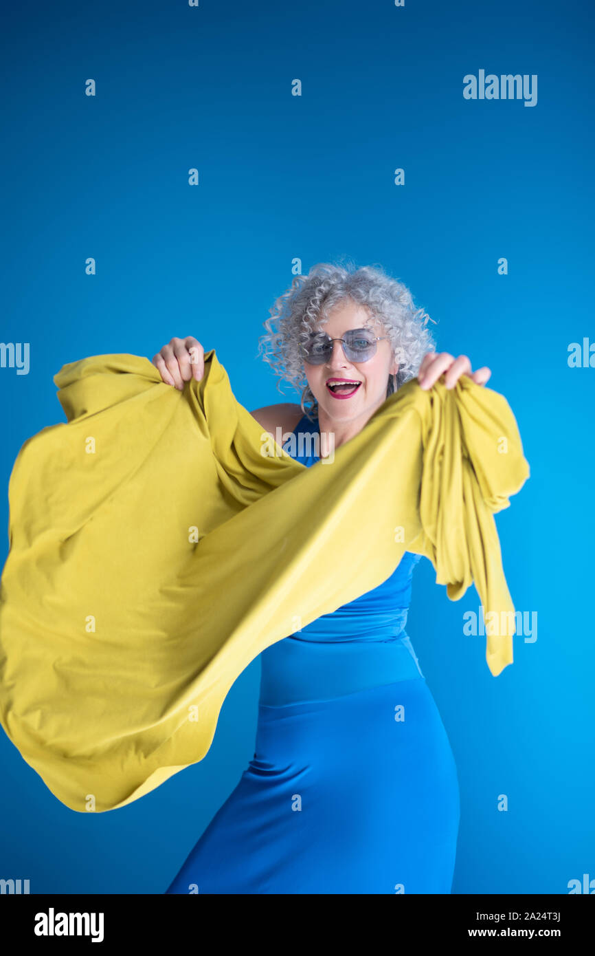 Photo model wearing long blue dress showing nice poses Stock Photo - Alamy
