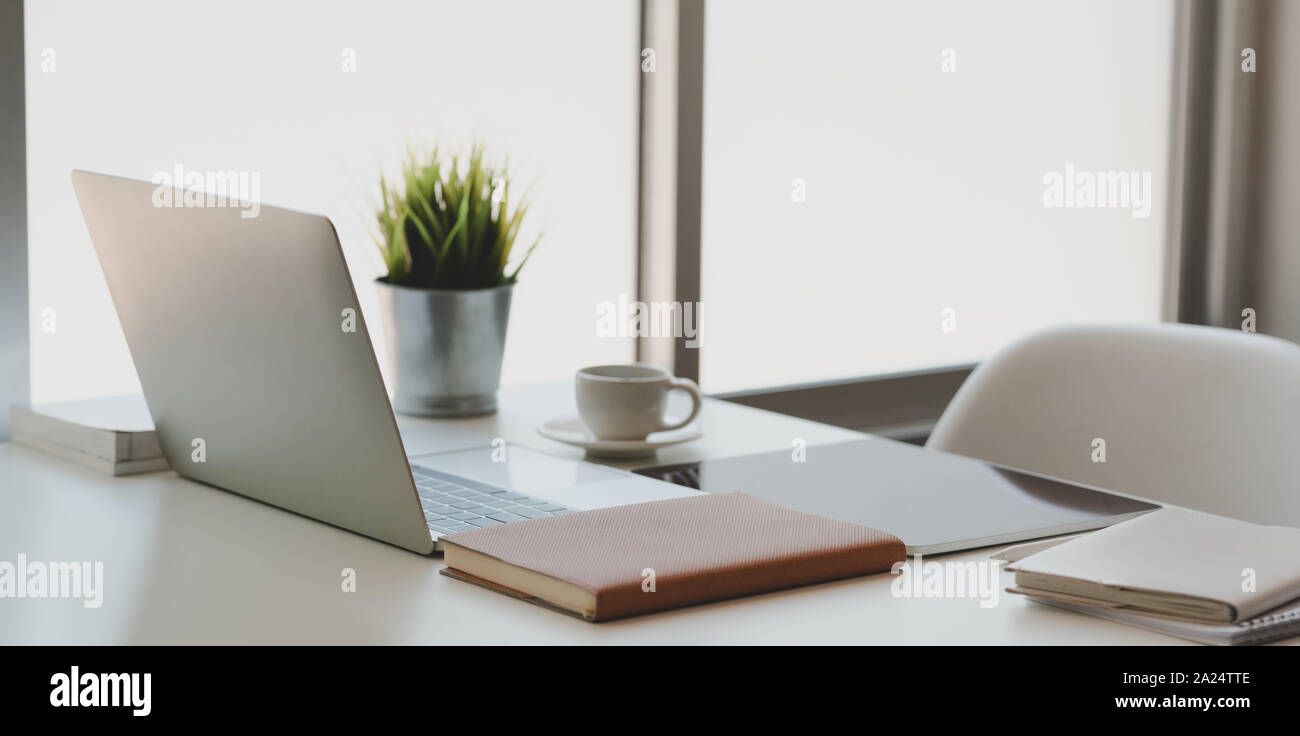 Modern workplace next to the windows with laptop computer, tablet and ...