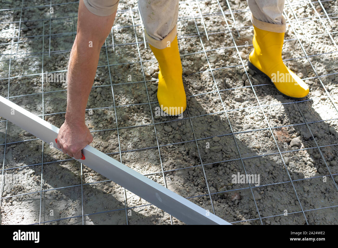 Construction worker in yellow rubber boots at the construction site ...