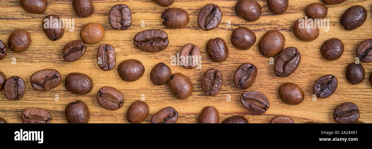 Coffee bean. The background of roasted coffee beans is brown on wooden ...