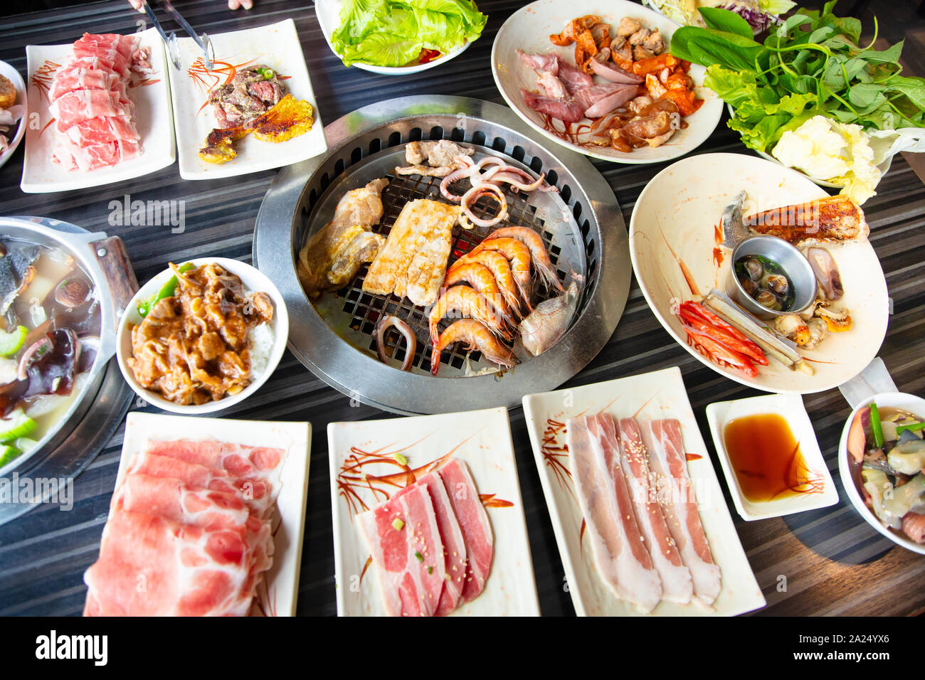 people eating barbecue beef in restaurant Stock Photo - Alamy