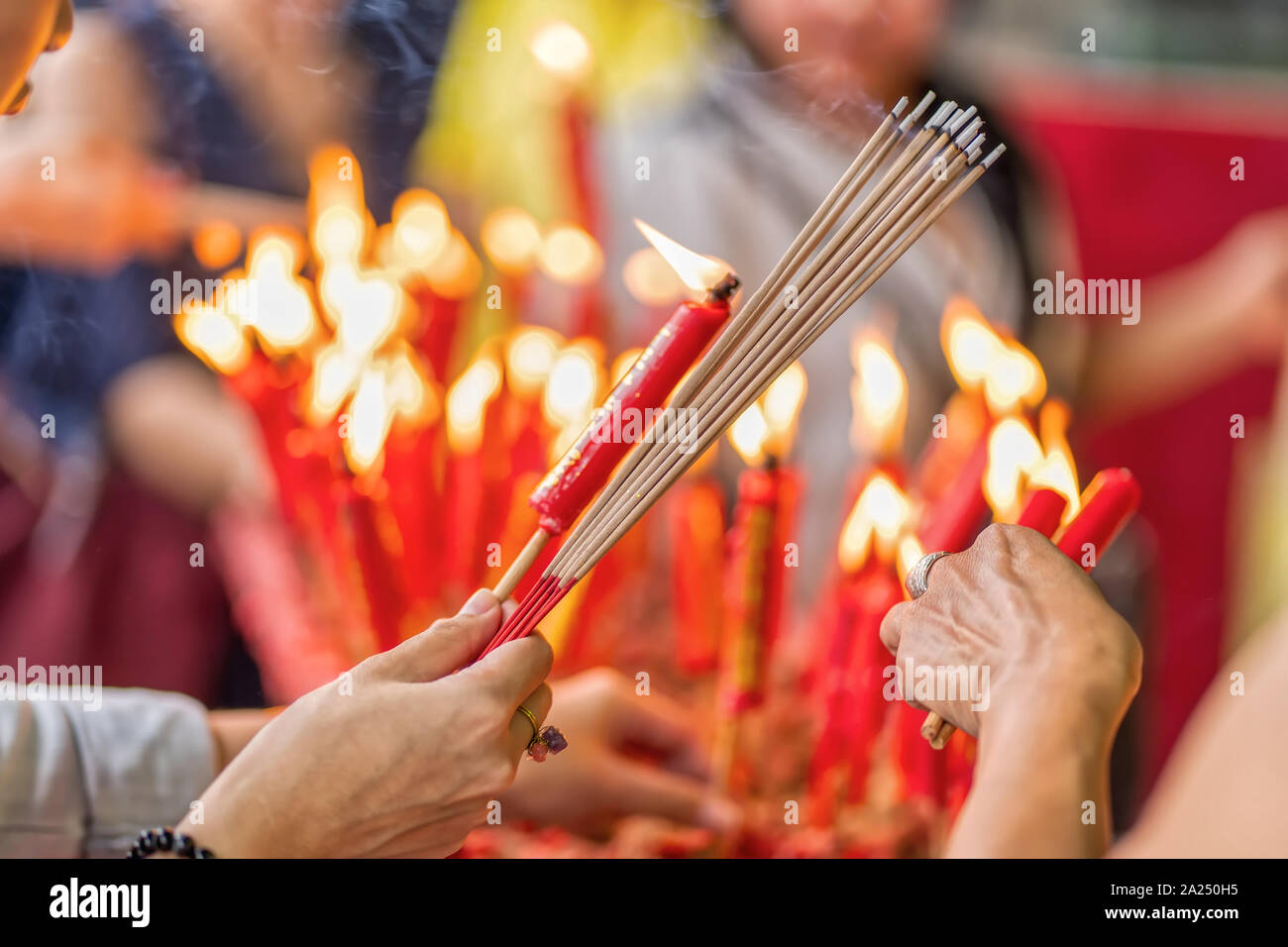The burning incense and candle worship in Buddhism Stock Photo - Alamy