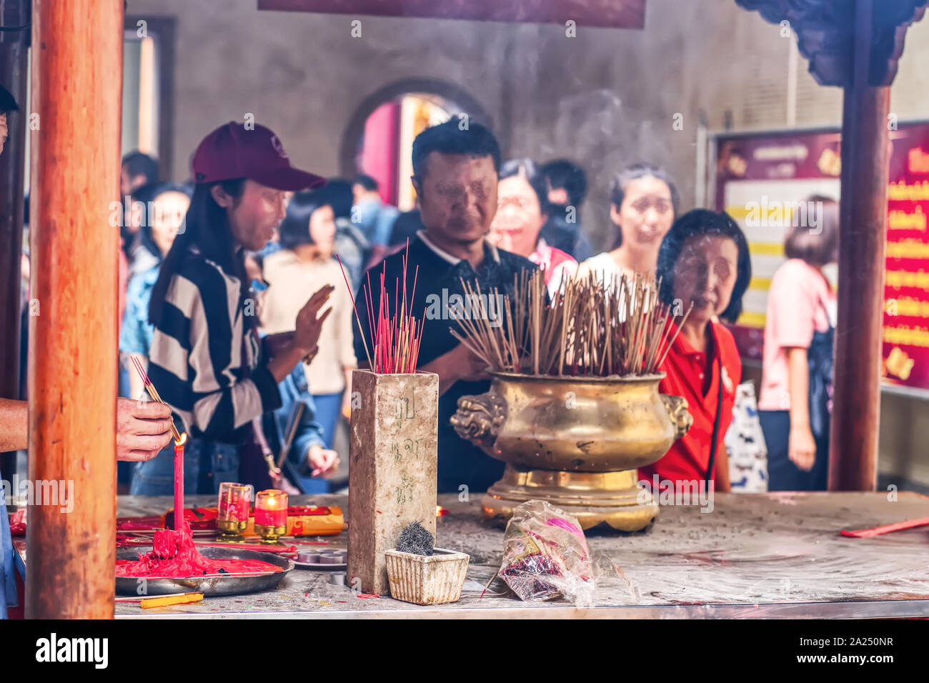 The burning incense and candle worship in Buddhism Stock Photo - Alamy