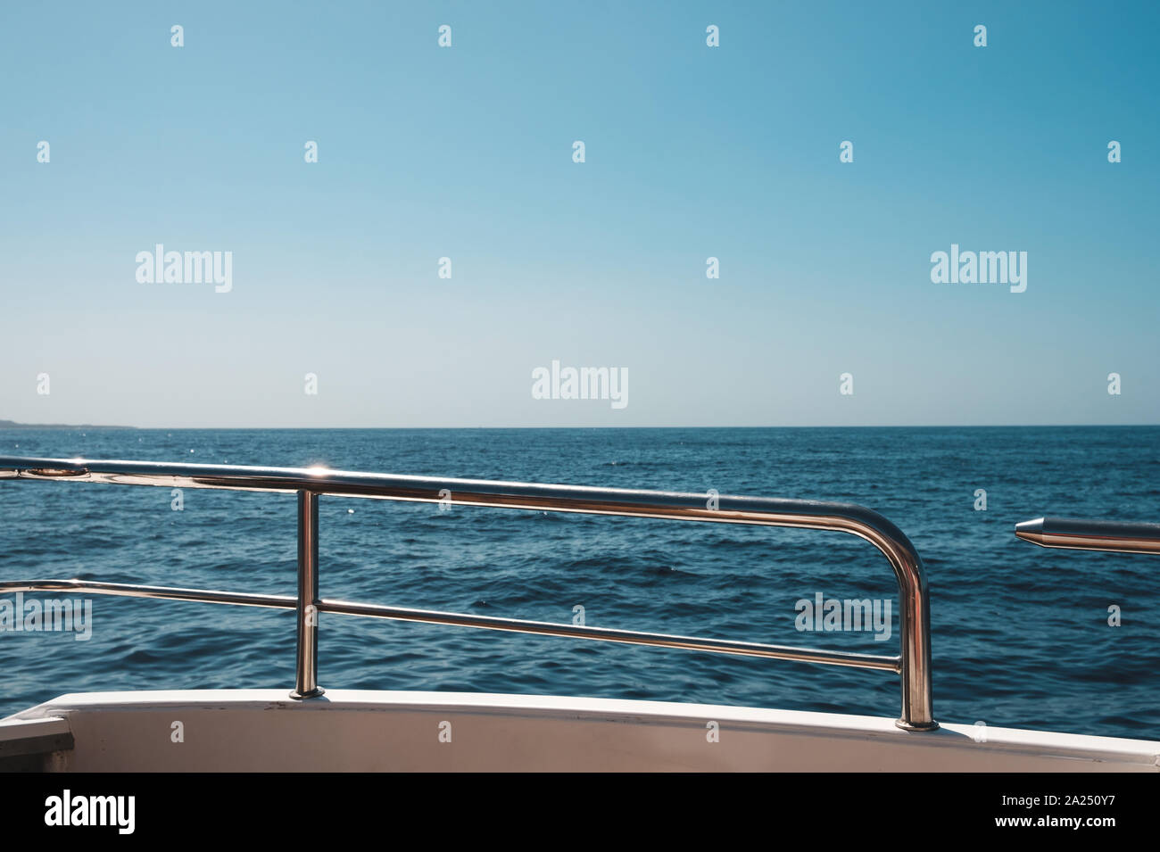 ocean and blue sky / sea view horizon behind boat railing Stock Photo ...