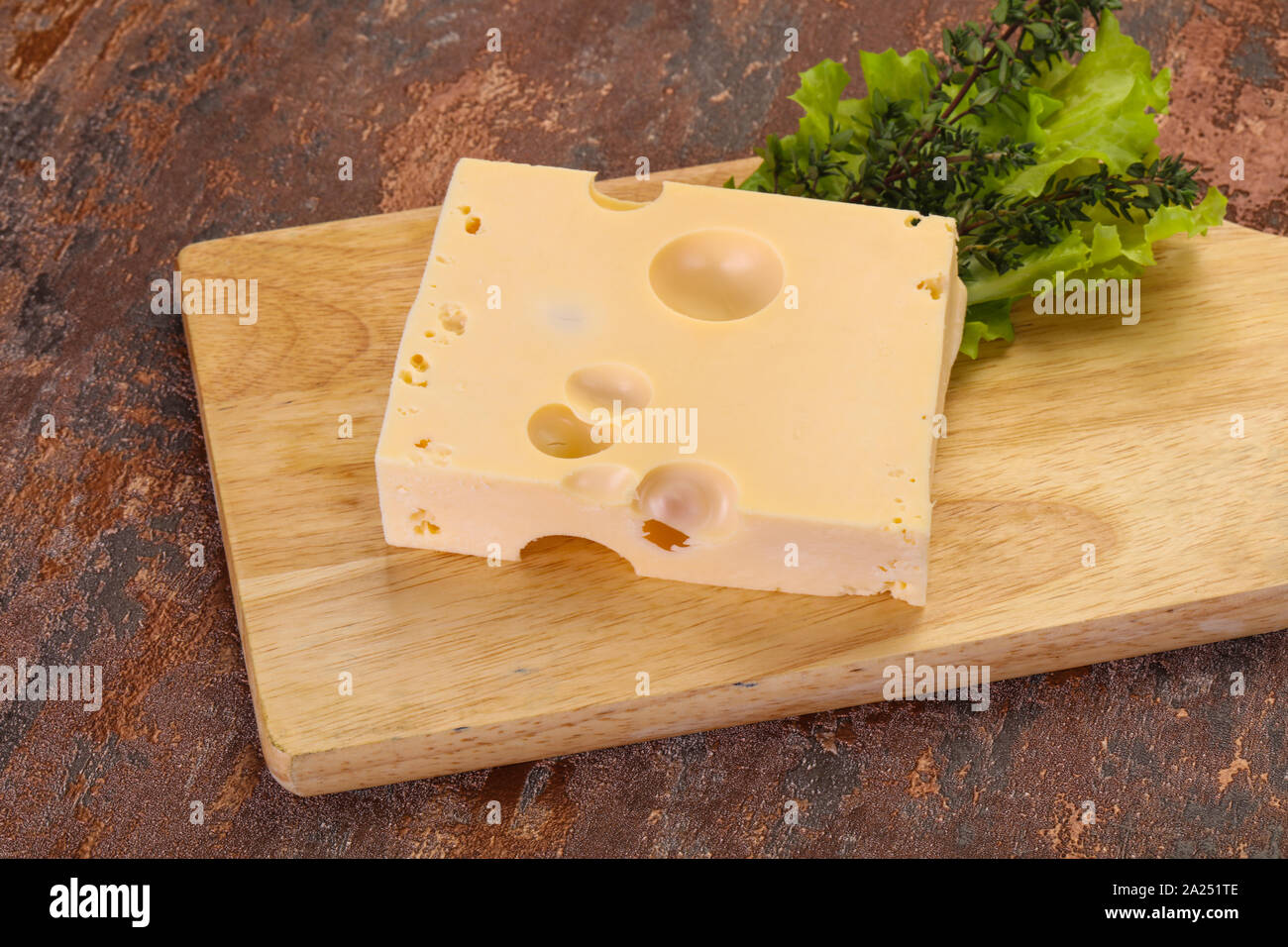 Maasdam cheese brick with thyme branch Stock Photo - Alamy