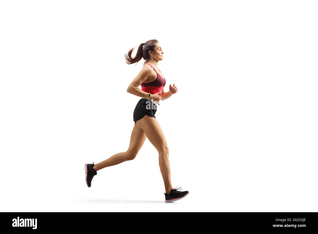 Full length profile shot of a young female athlete in sportswear ...