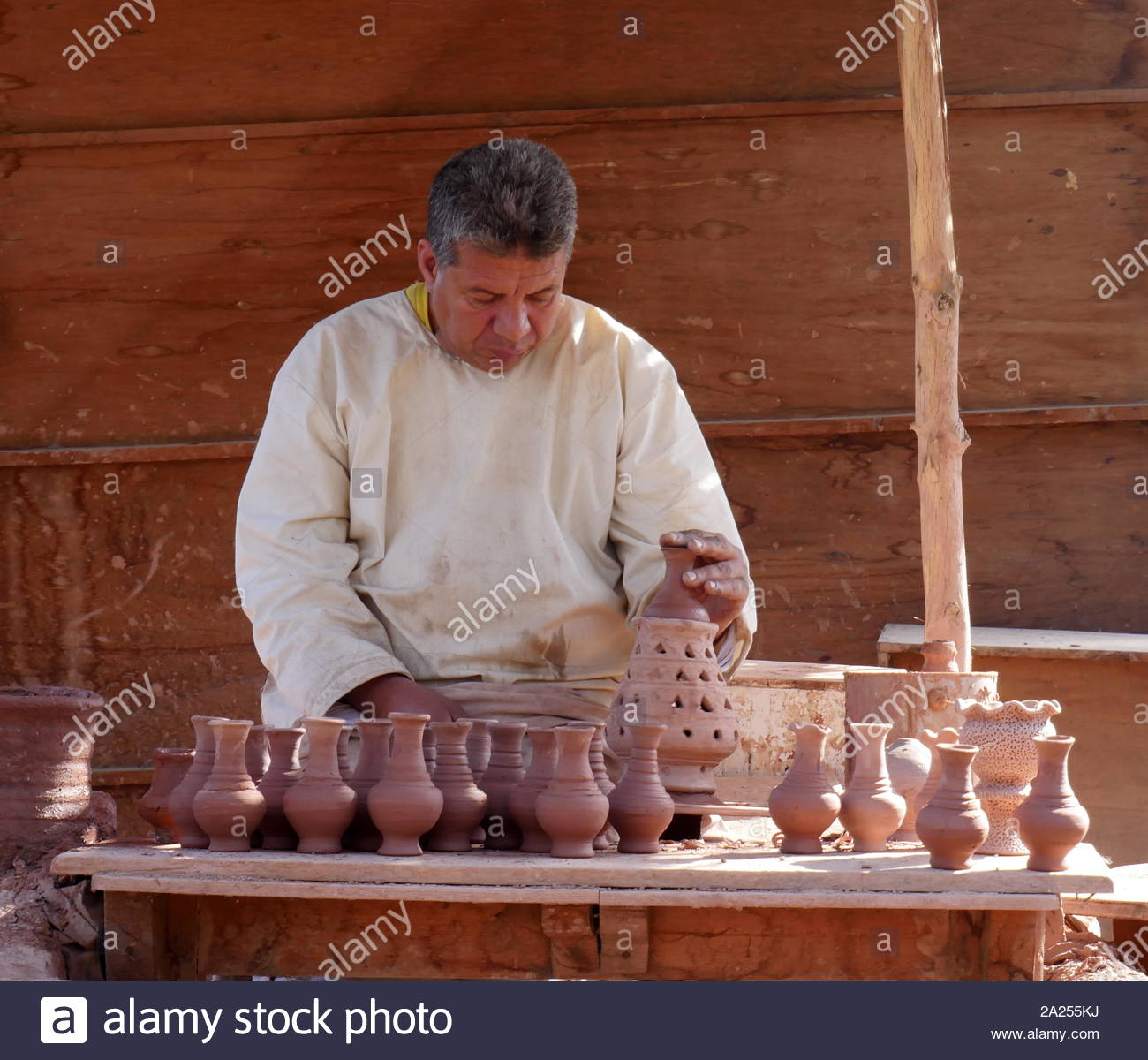 Re-enactment of an ancient Egyptian potter creating pottery objects and ...