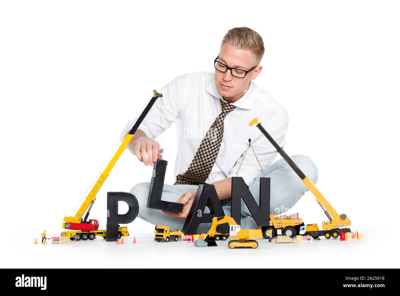 Build up a plan: Businessman building plan-word Stock Photo - Alamy