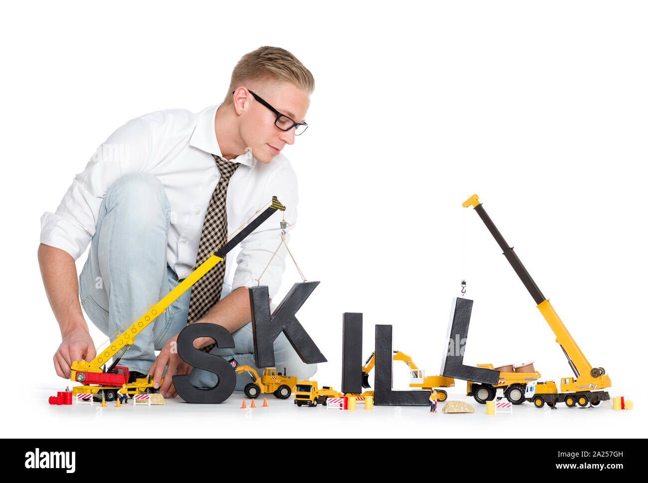 Developing skills: Businessman building skill-word Stock Photo - Alamy
