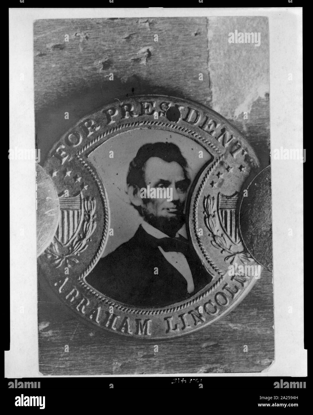 Photograph of a campaign button with portrait of Abraham Lincoln and ...
