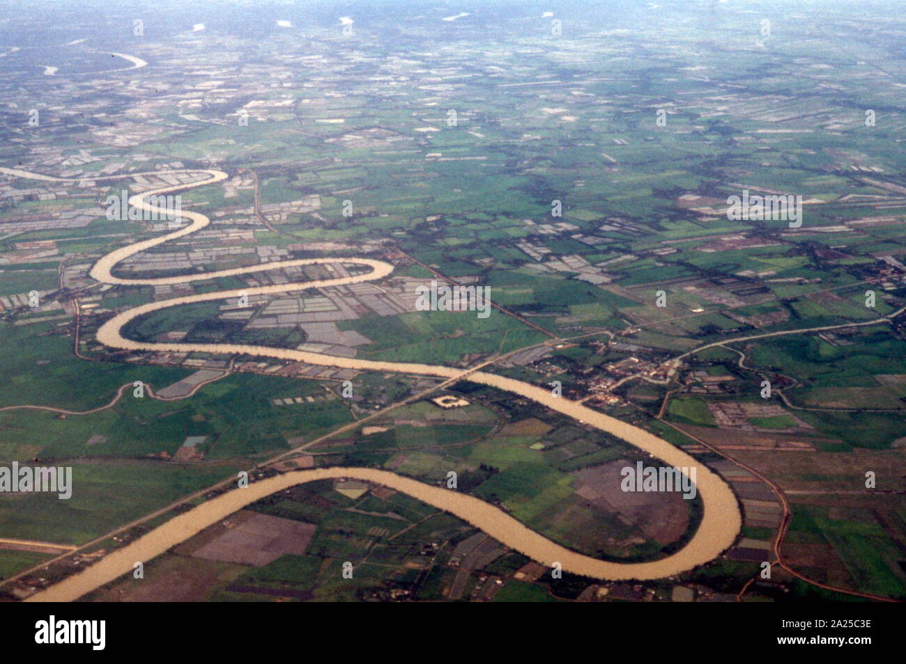 Vietnamese rice fields line the Mekong river as it passes through South ...