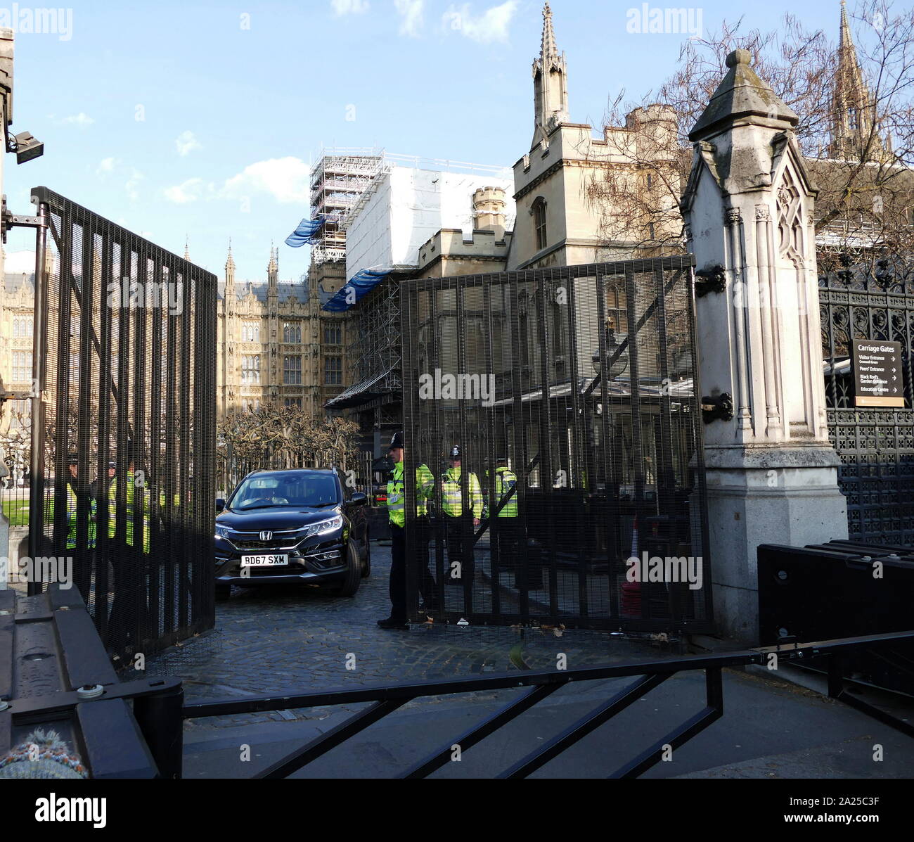Ministerial car leaves the high security gate at the entrance to the ...