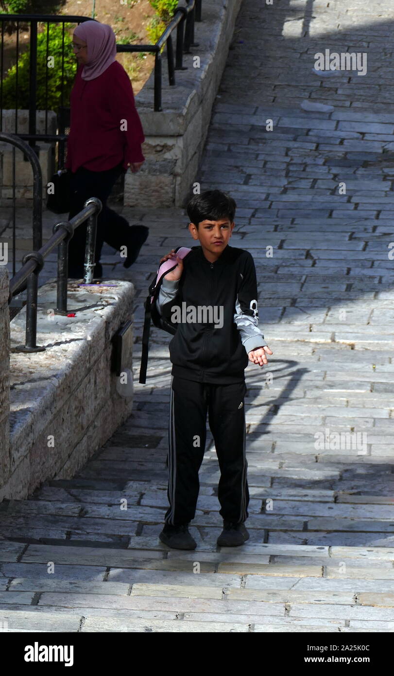Arab boy going on their way to school in the old city of Jerusalem ...