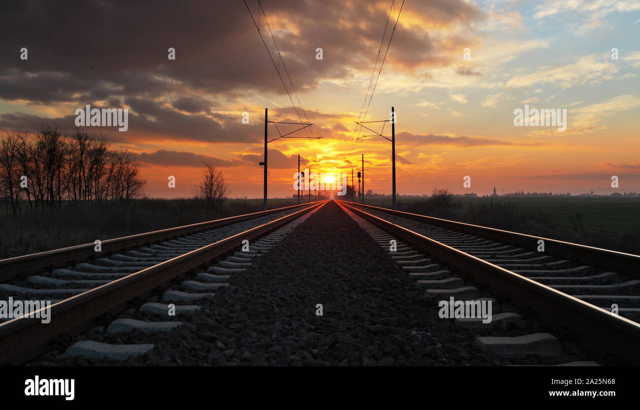 Railway, railroad at a nice dramatic sunset Stock Photo - Alamy