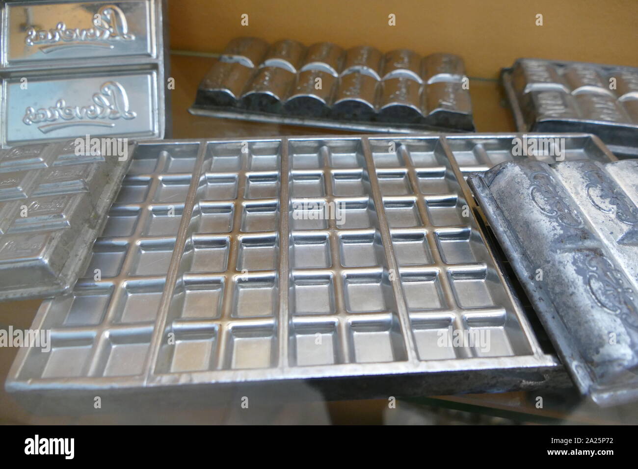 Metal moulds for mass produced chocolate bars Stock Photo - Alamy