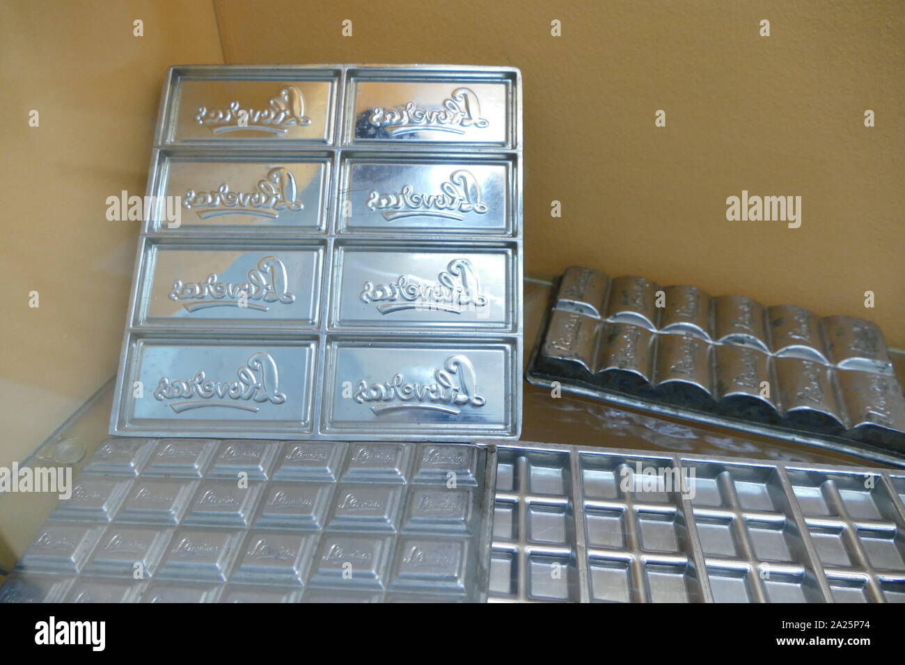 Metal moulds for mass produced chocolate bars Stock Photo - Alamy