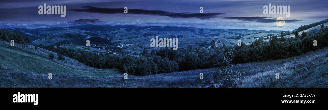 panorama of mountainous countryside at night in full moon light ...