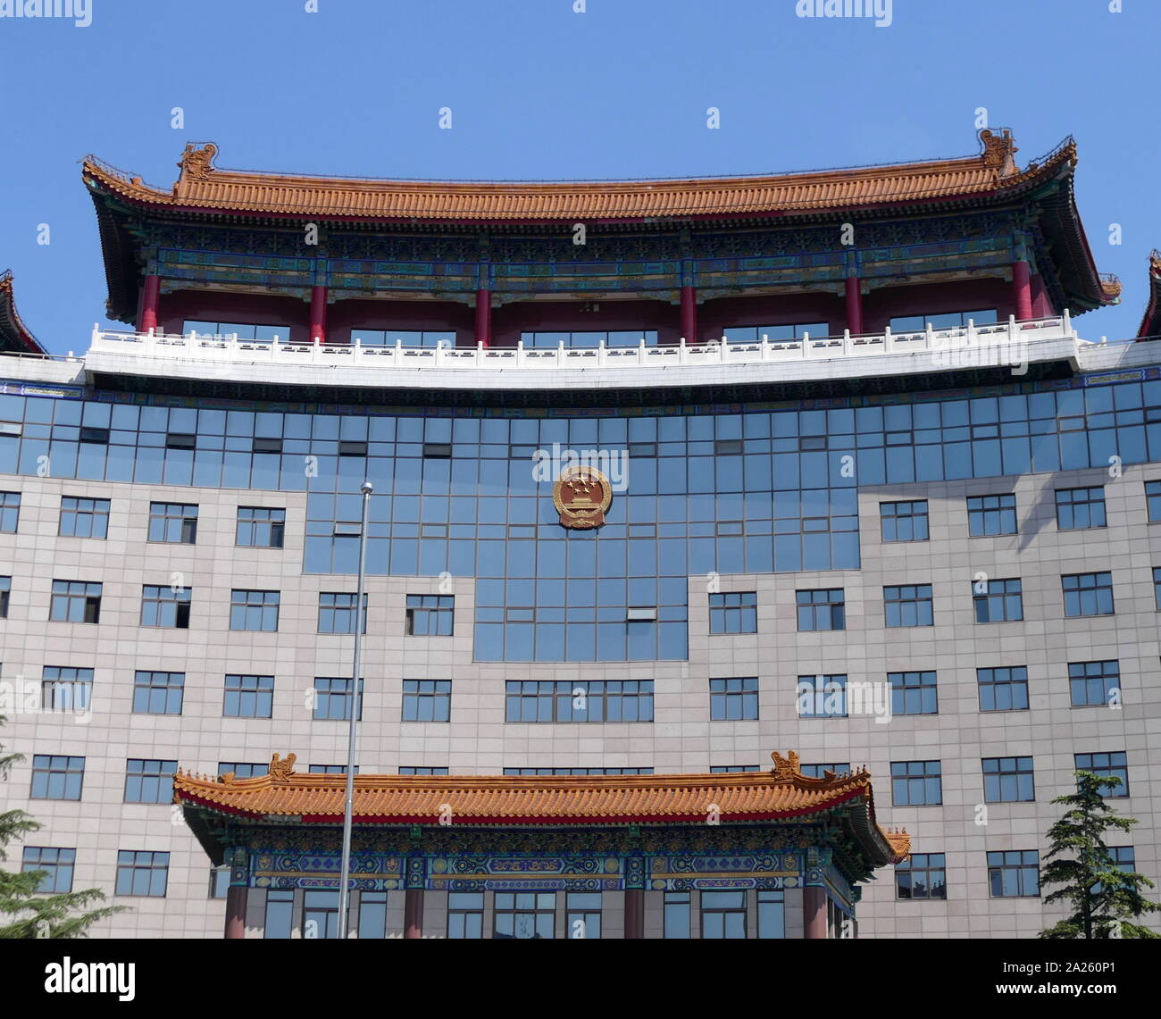 The Chinese State emblem above the entrance of a government building ...