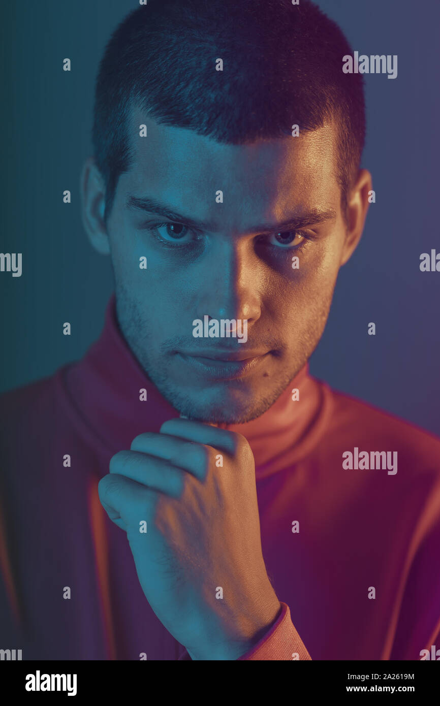 Close-up portrait of attractive male model. Retro wave portrait of a ...