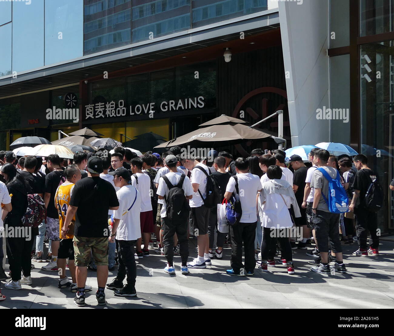 Young fashionable Chinese crowd gathers outside a store to take part in ...