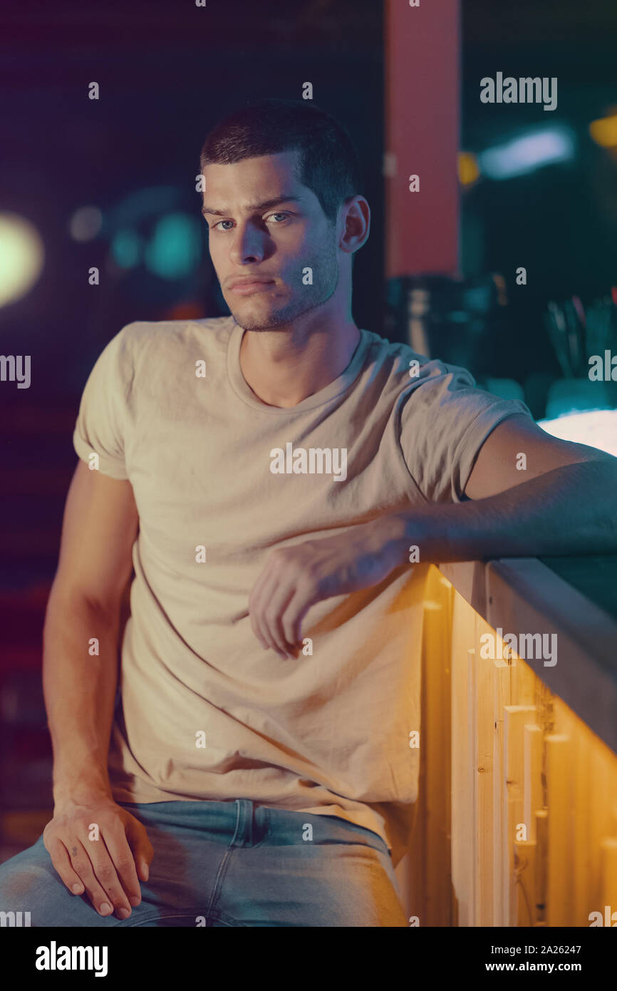 Close-up portrait of attractive male model. Retro wave portrait of a ...