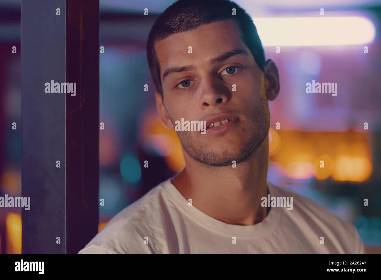 Close-up portrait of attractive male model. Retro wave portrait of a ...