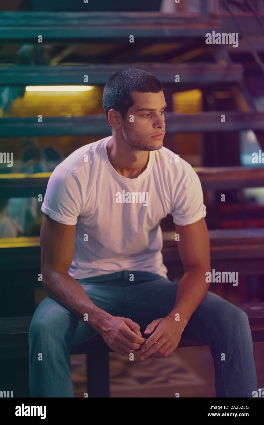 Close-up portrait of attractive male model. Retro wave portrait of a ...