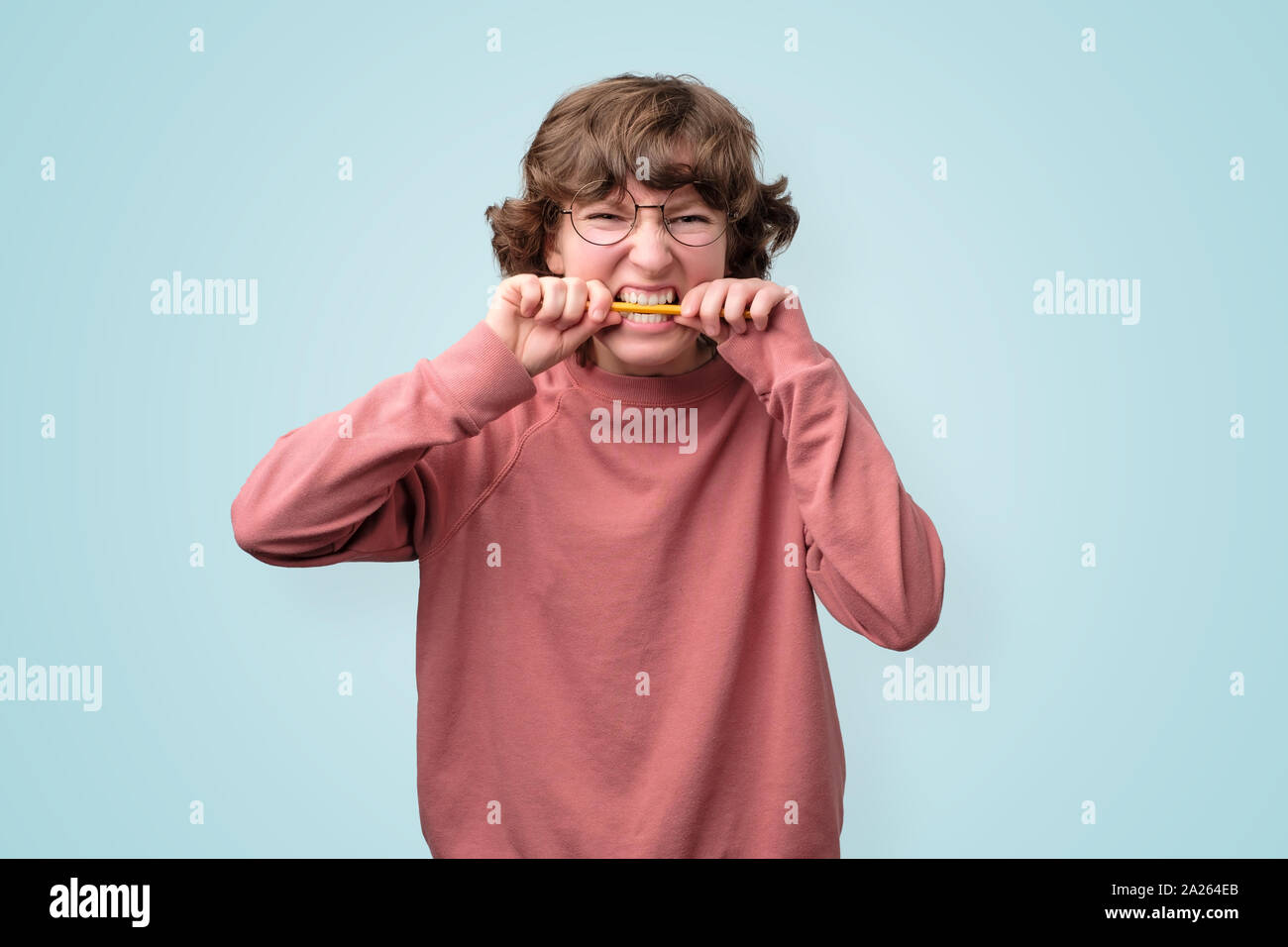 Biting pencil hi-res stock photography and images - Alamy