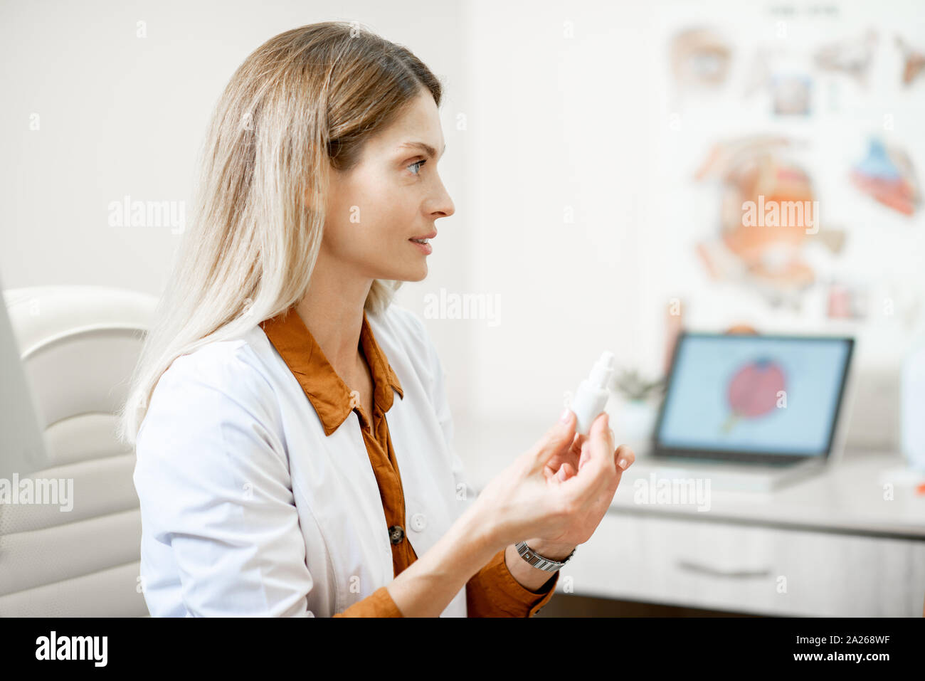 Female ophthalmologist with eye medicine in the dropper during medical ...