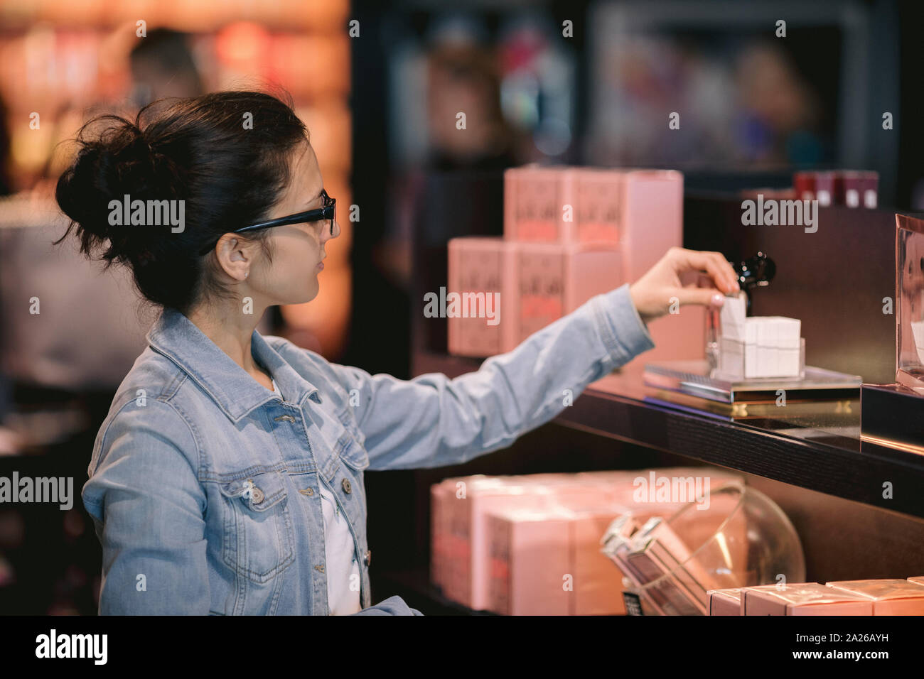 woman customer looking cosmetics in make-up shop Stock Photo - Alamy