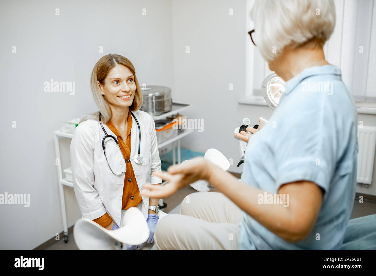 Gynecologist listening to a senior woman patient during a medical ...