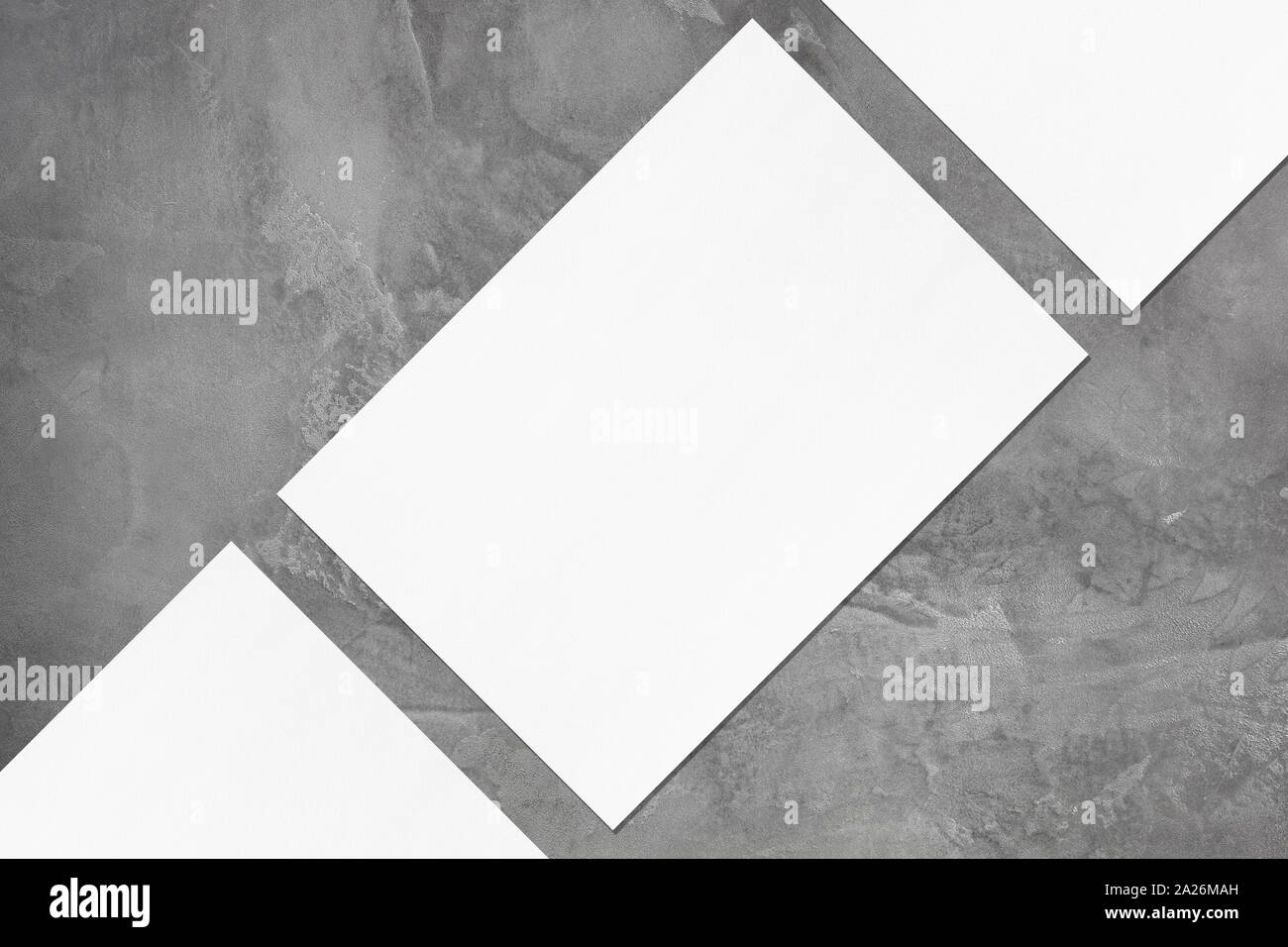 Closeup of three empty white rectangle poster or card mockups lying ...