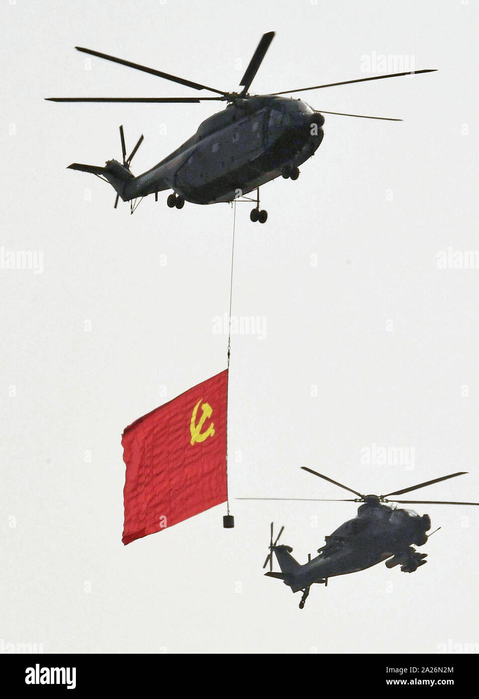 Beijing, China. 1st Oct 2019. Helicopters fly the flag of the Communist ...
