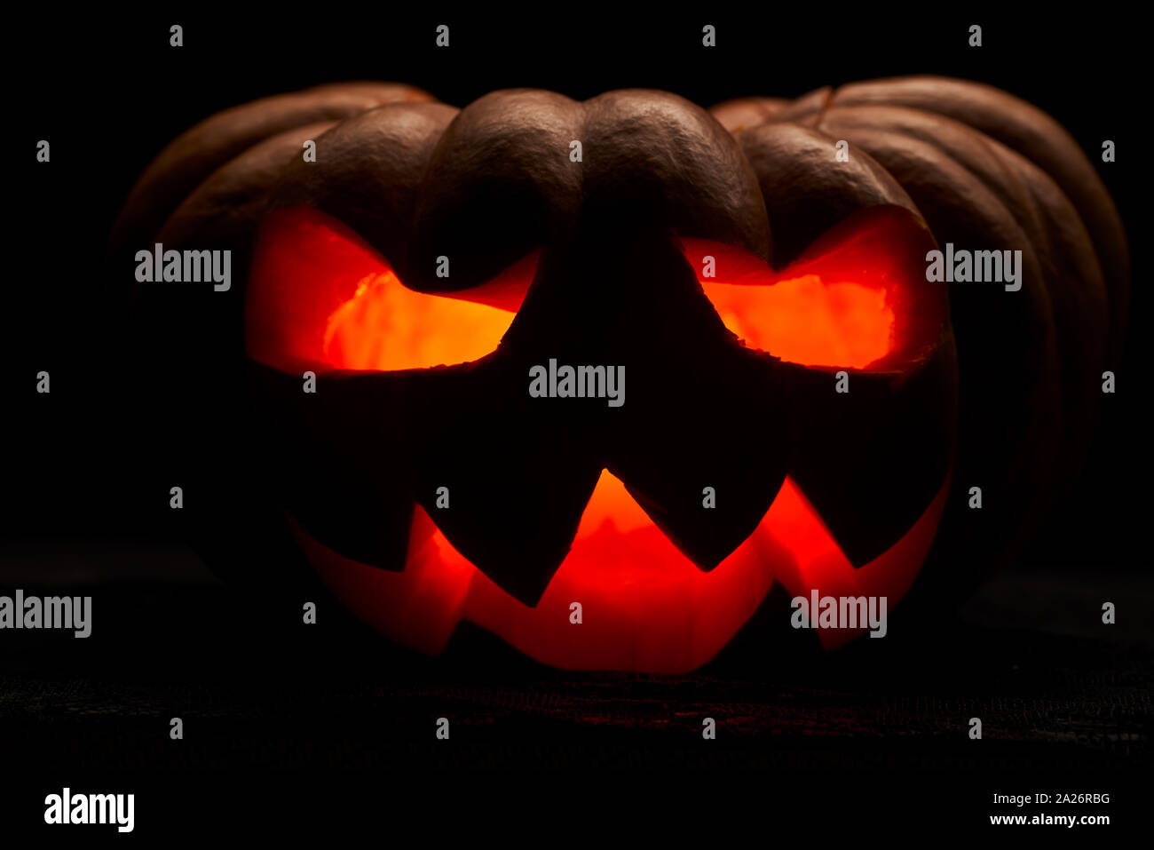 Close up photo of one halloween pumpkin with burning mouths on empty ...