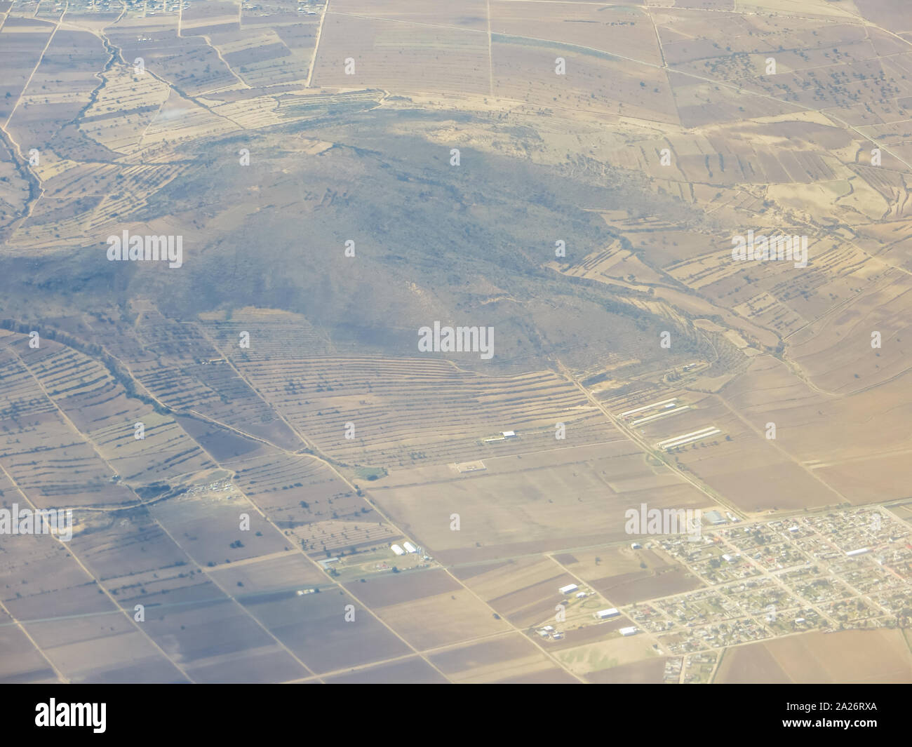 Aerial view of planting fields with small hill and small town Stock ...
