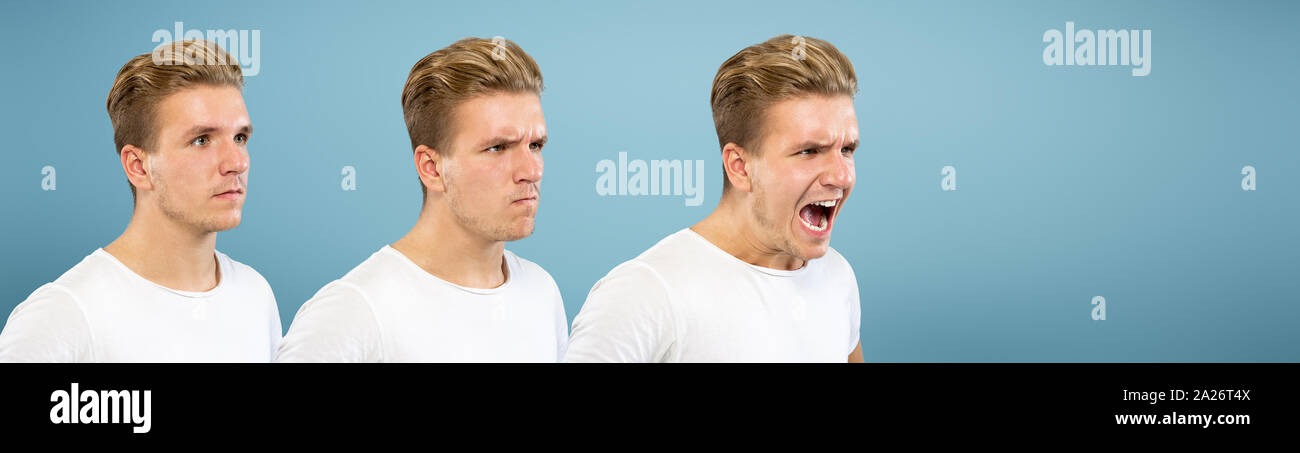 Caucasian young man's close up portrait on blue studio background ...